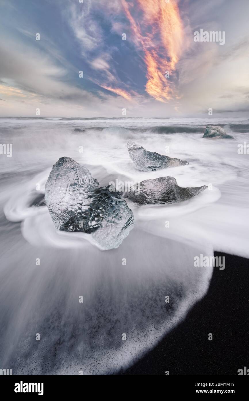 Ice blocks on a beach with strong surf, the dynamics of a wave can be ...