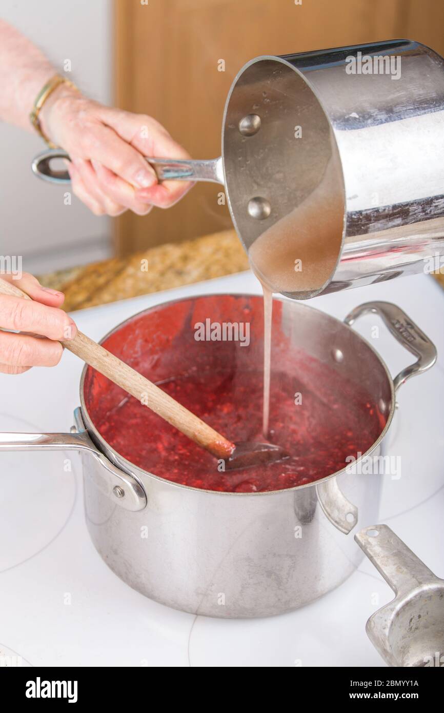 Woman Stirring Pot On Stove High Resolution Stock Photography and ...