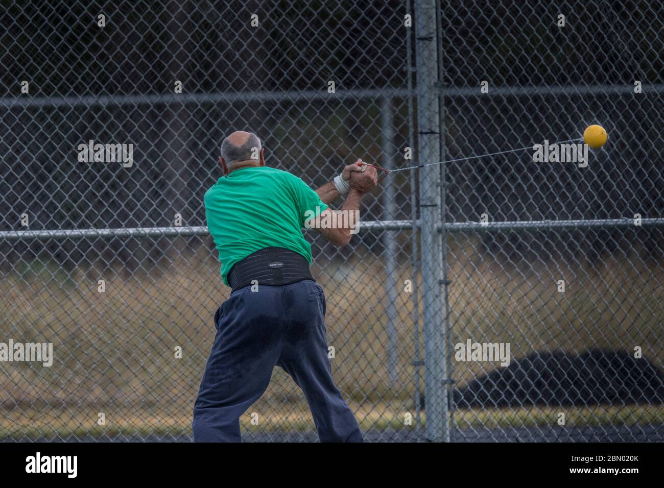 Senior Males competing in Summer Games-Hammer throw. Action and facial ...