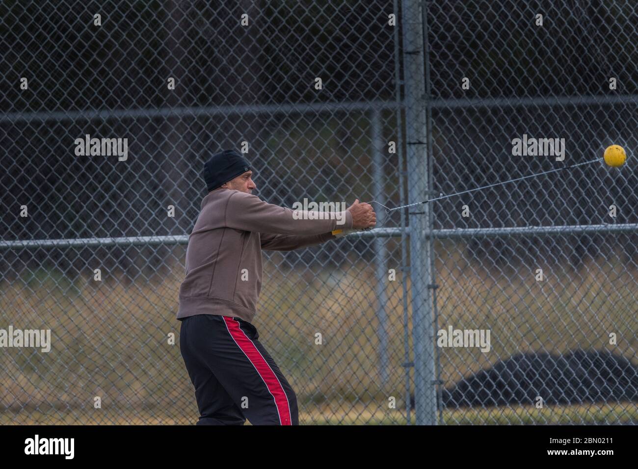 Senior Males competing in Summer Games-Hammer throw. Action and facial ...