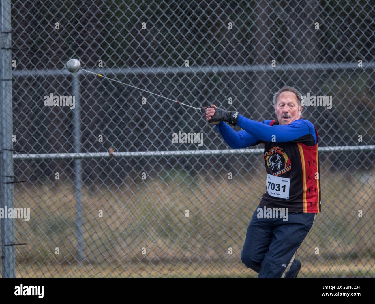 Senior Males competing in Summer Games-Hammer throw. Action and facial ...