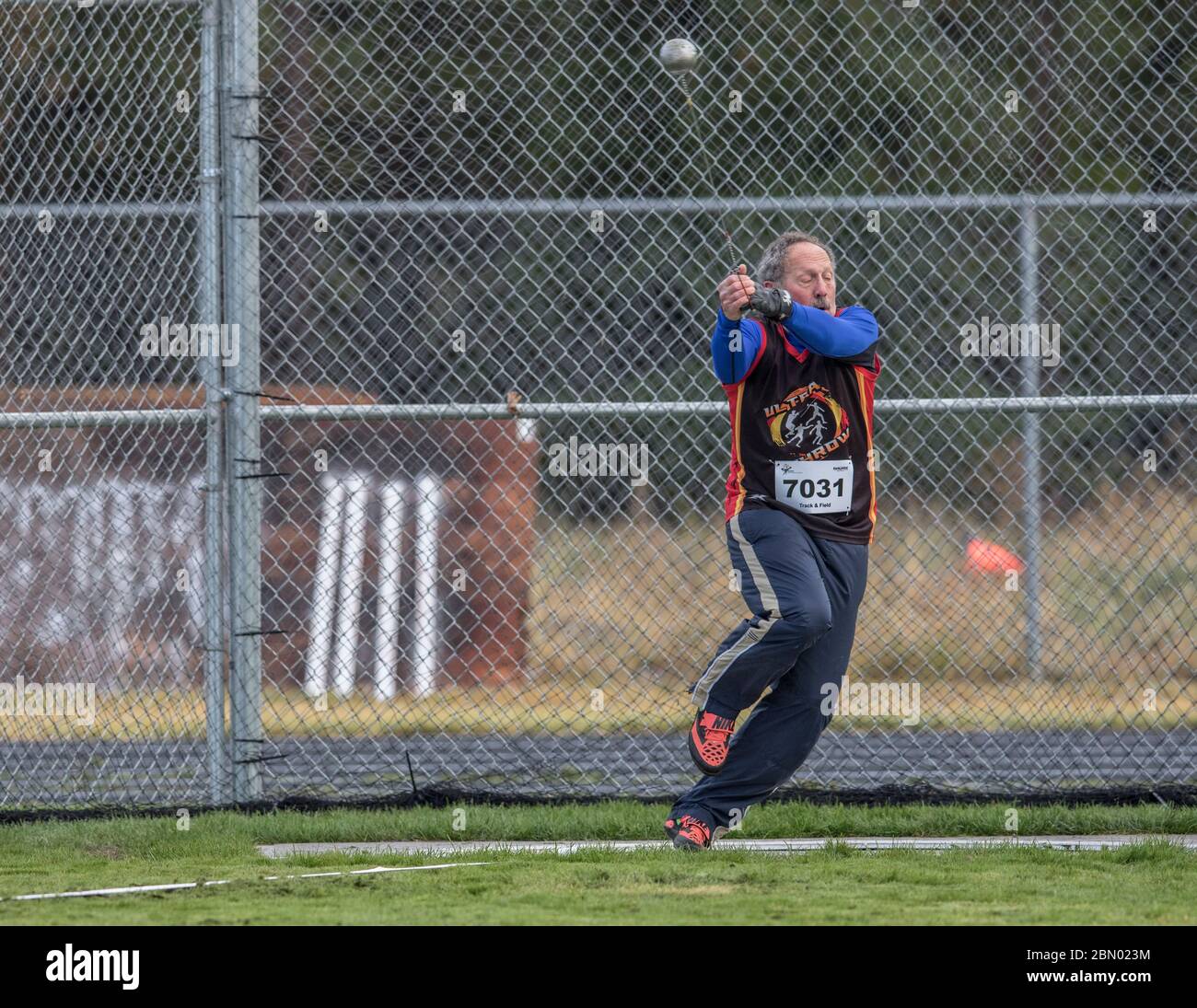 Senior Males competing in Summer Games-Hammer throw. Action and facial ...