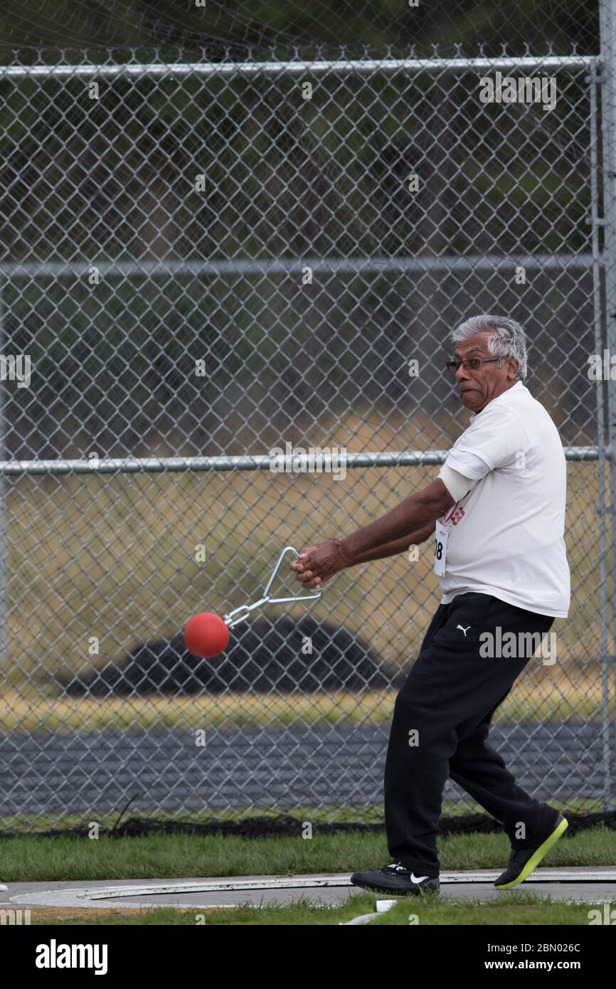 Senior Males competing in Summer Games-Hammer throw. Action and facial ...