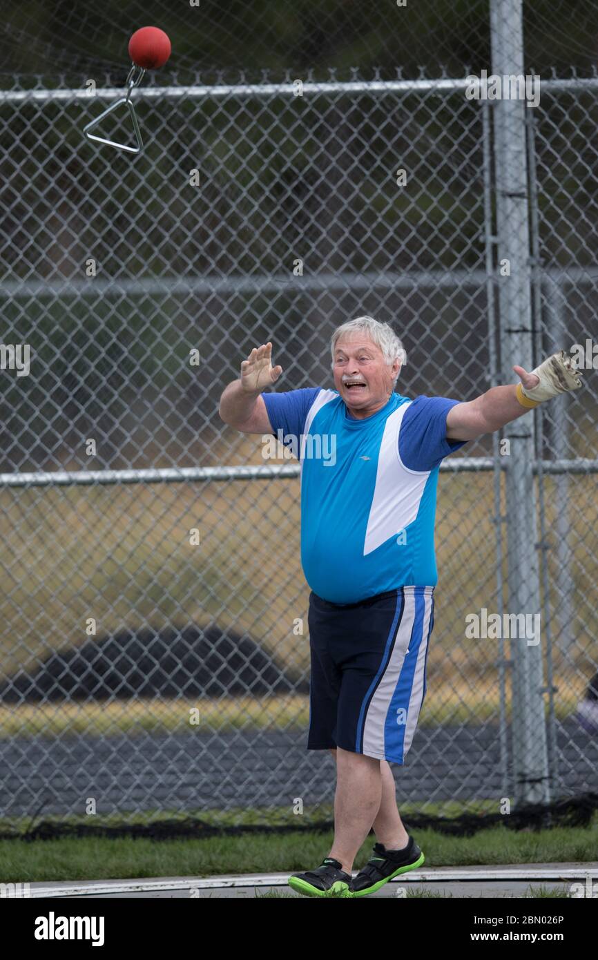 Senior Males competing in Summer Games-Hammer throw. Action and facial ...