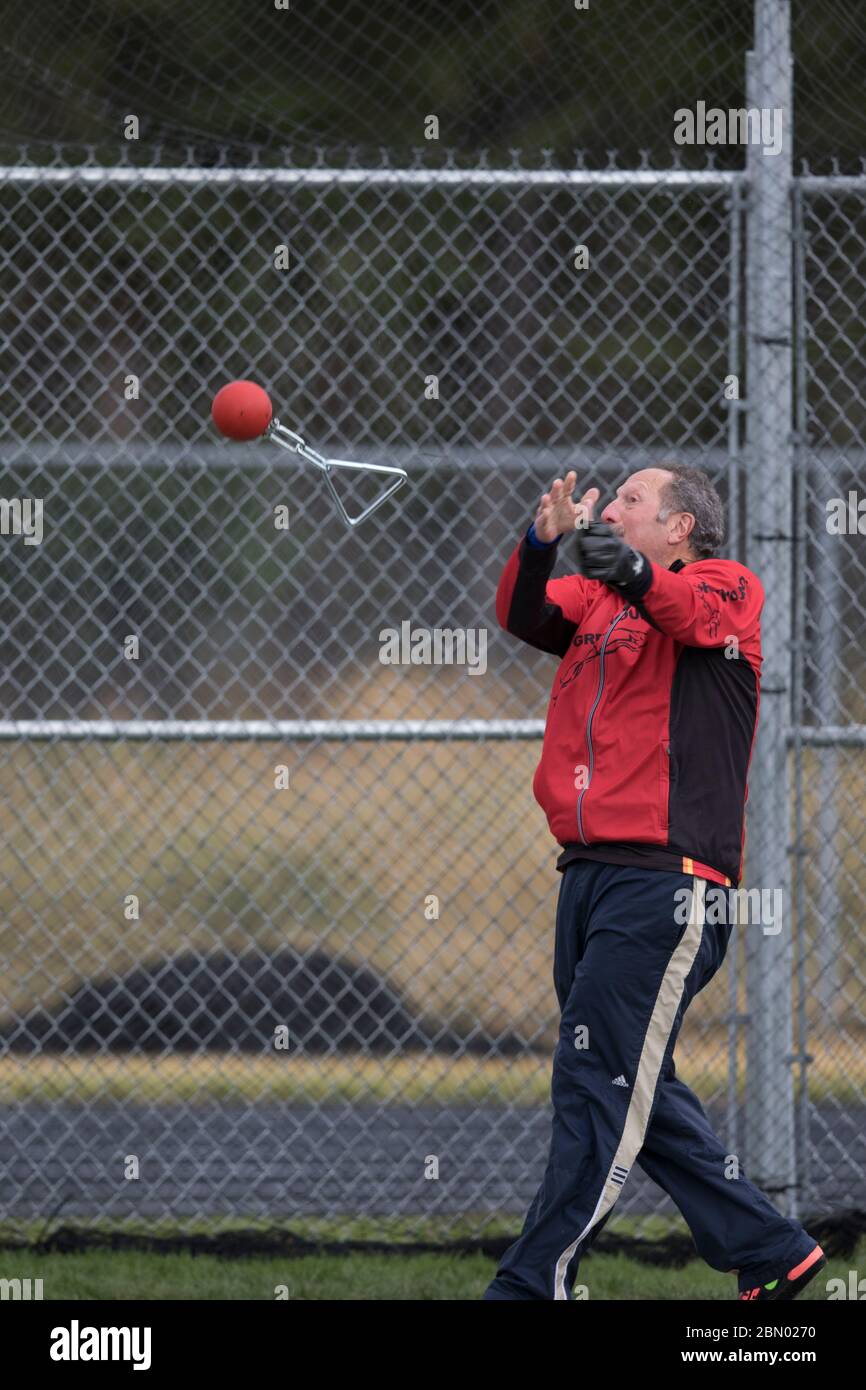 Senior Males competing in Summer Games-Hammer throw. Action and facial ...