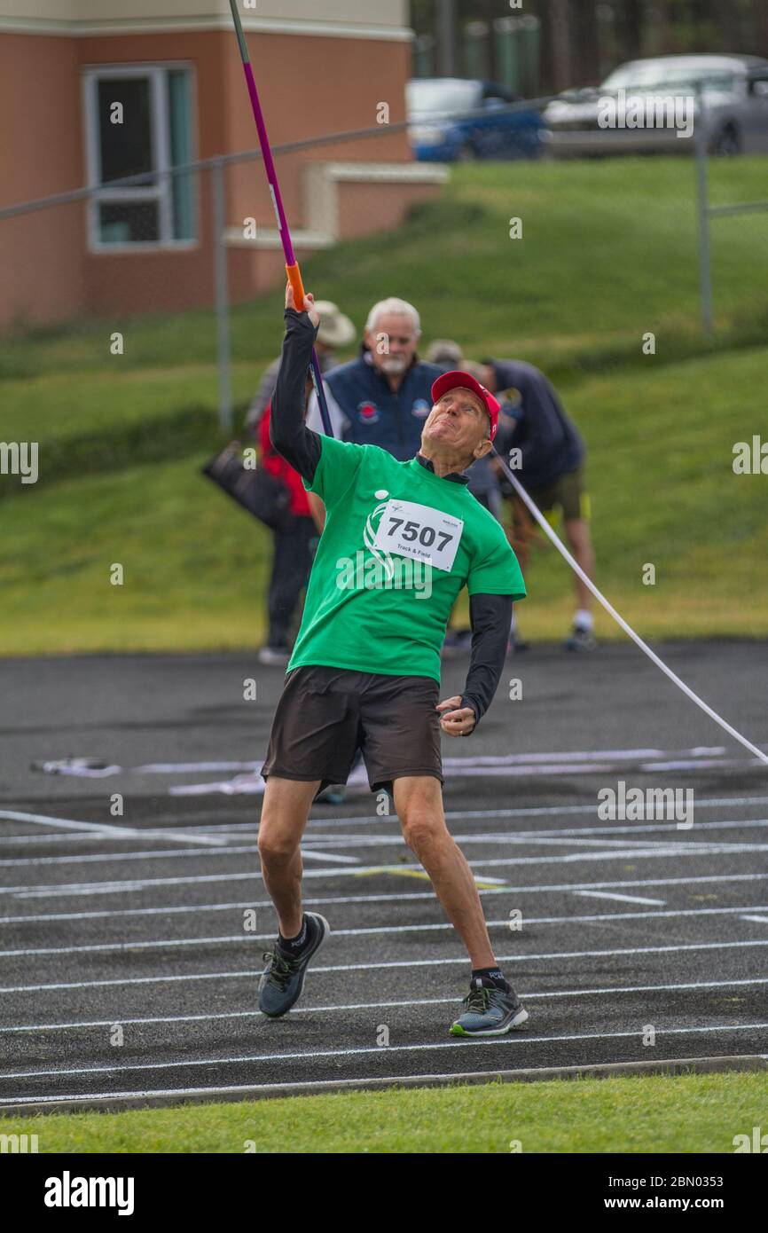 Competing in javelin throw, 70 year old male. Just before release Stock ...