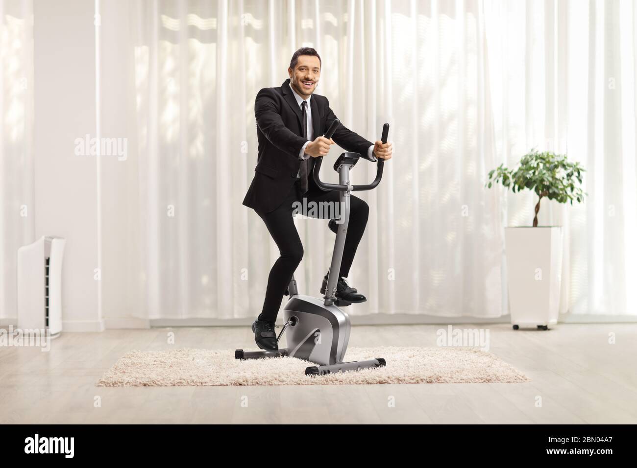 People stationary bike at home hi-res stock photography and images - Alamy