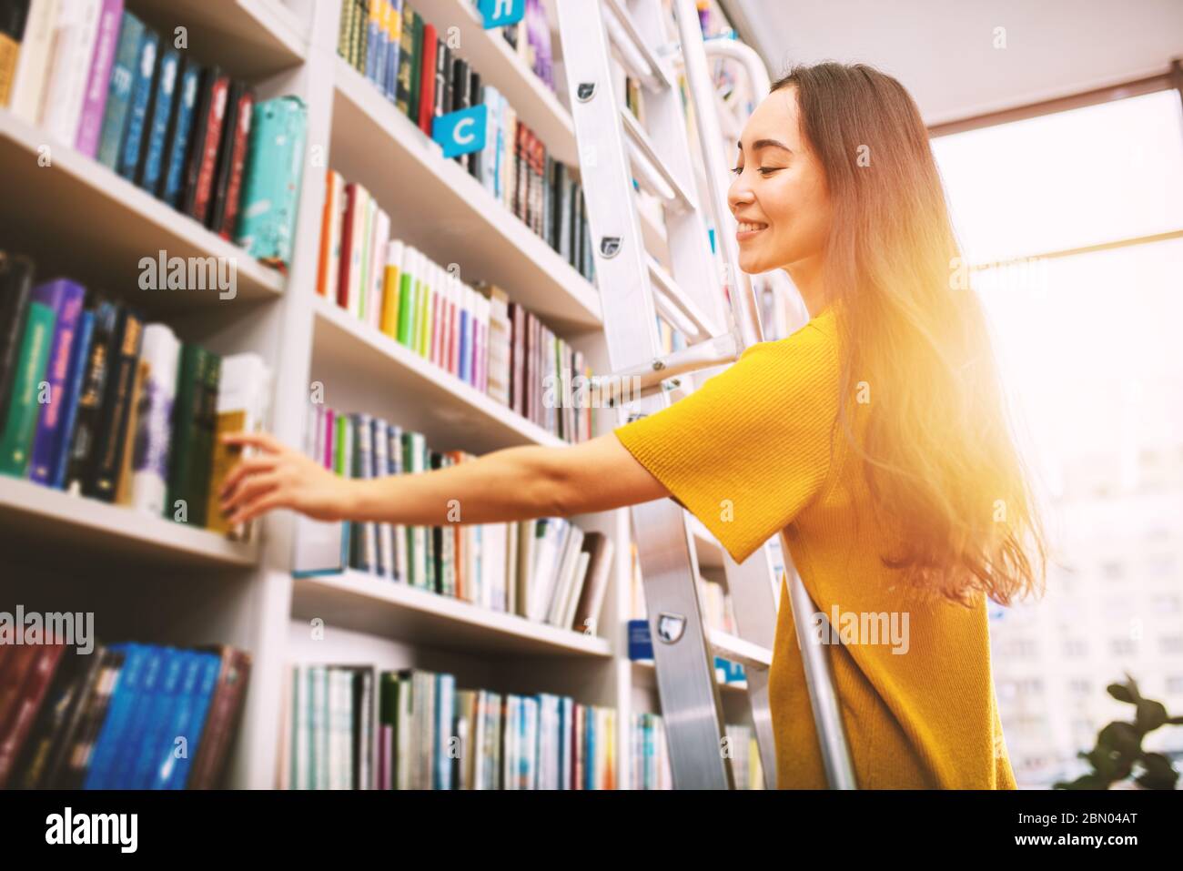 Girl choose a book to read. Concept of culture and studying Stock Photo ...