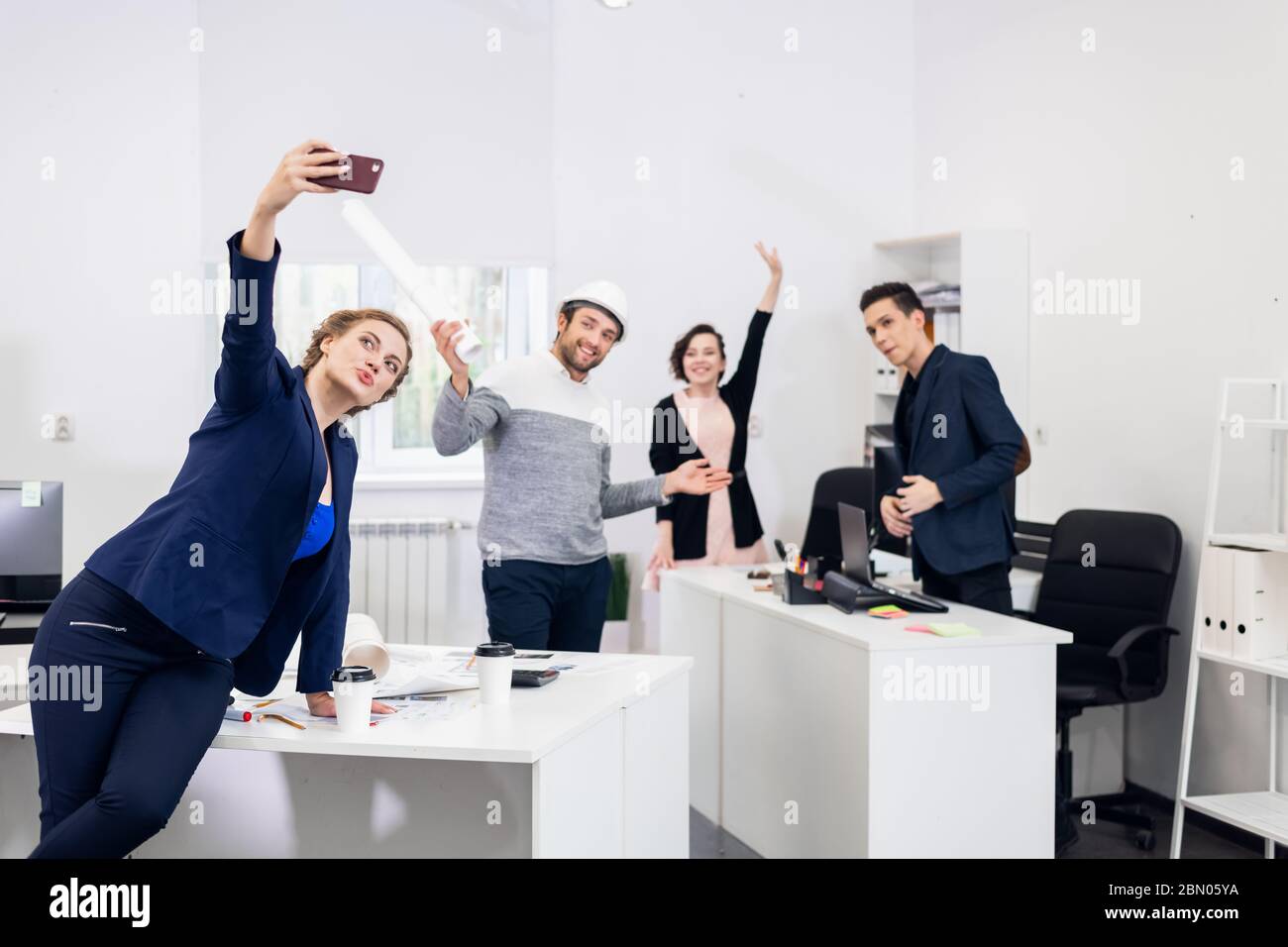 Employees having fun in the office, posing and taking selfies wi Stock ...