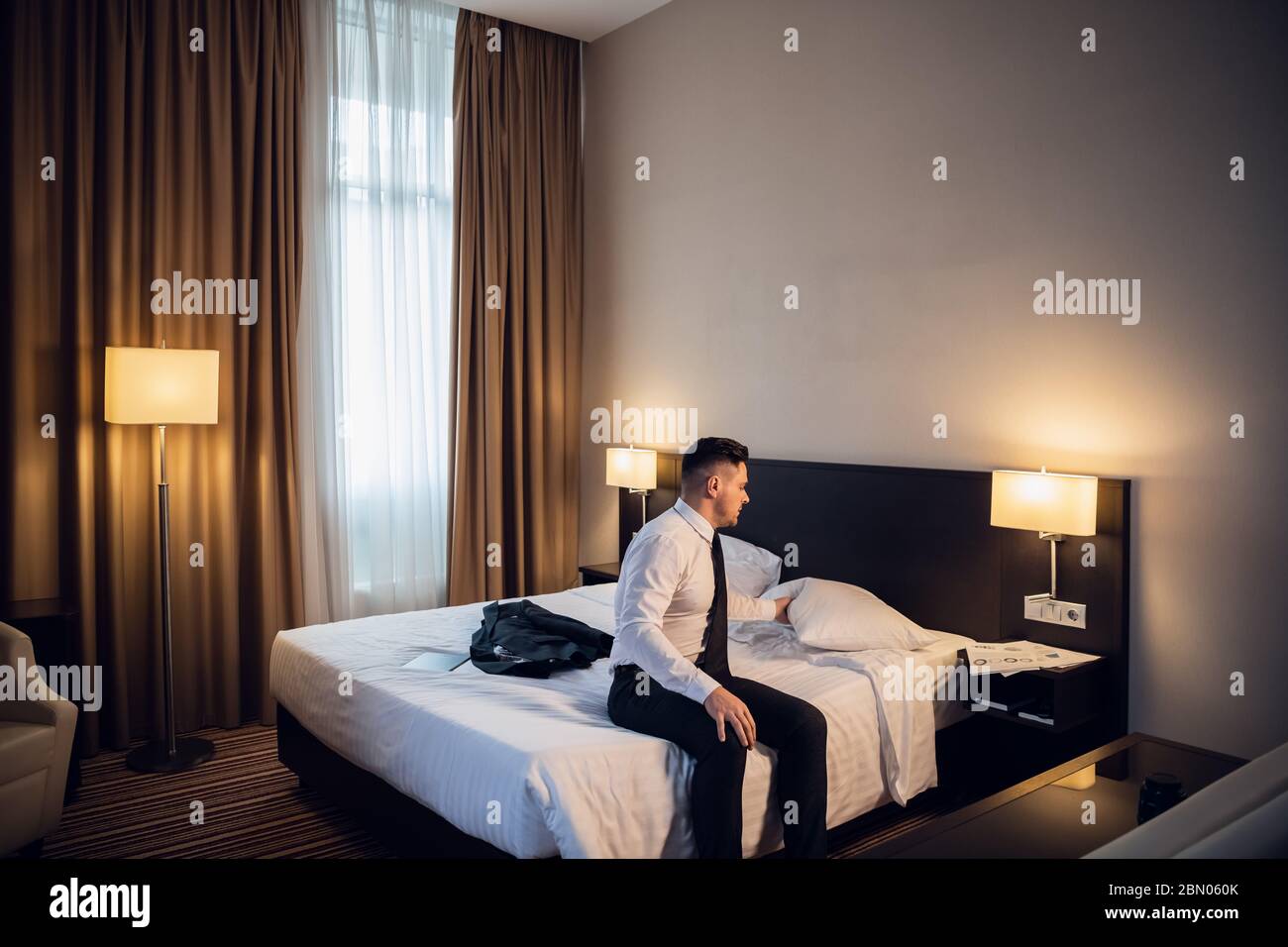 Tired Businessman preparing to have a little rest in his hotel r Stock ...