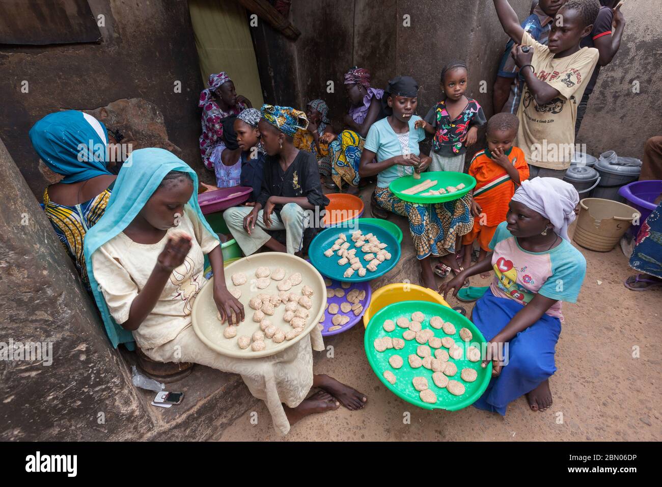 Beautiful African girls in colorful clothes and turban making ...