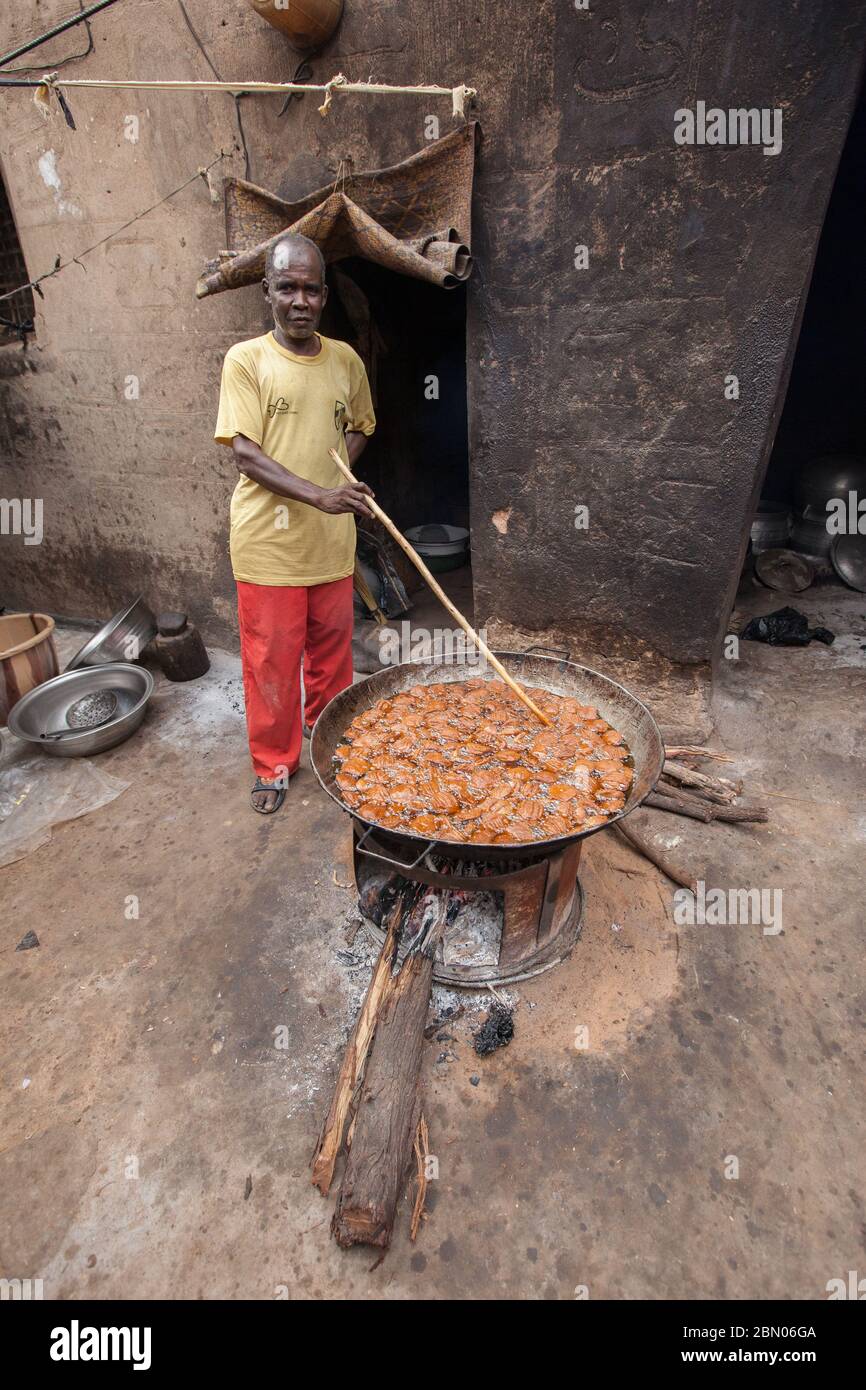 African man cooks traditional meal outdoor kitchen Stock Photo - Alamy