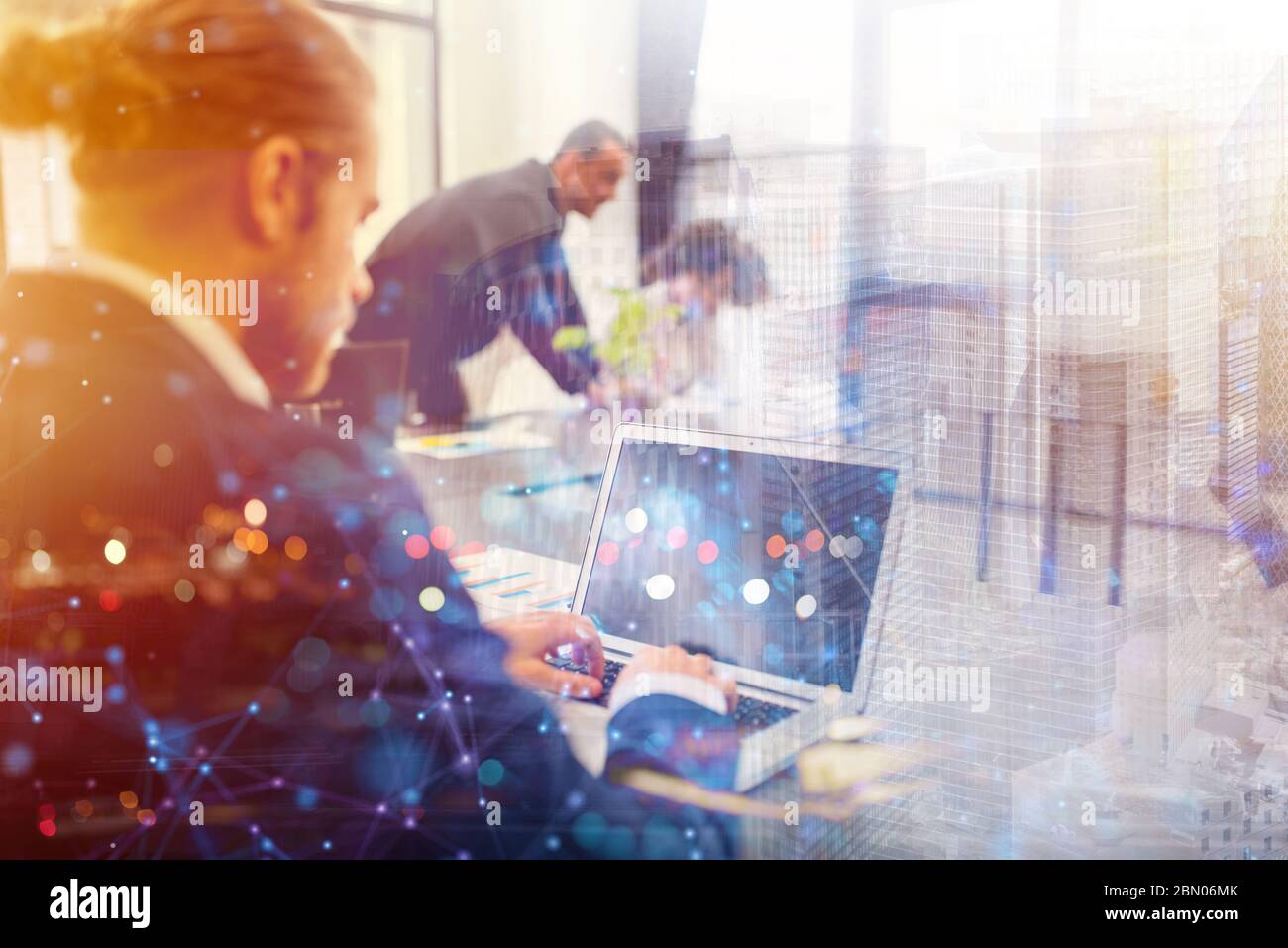 Businessman works in office with a laptop with internet effects ...