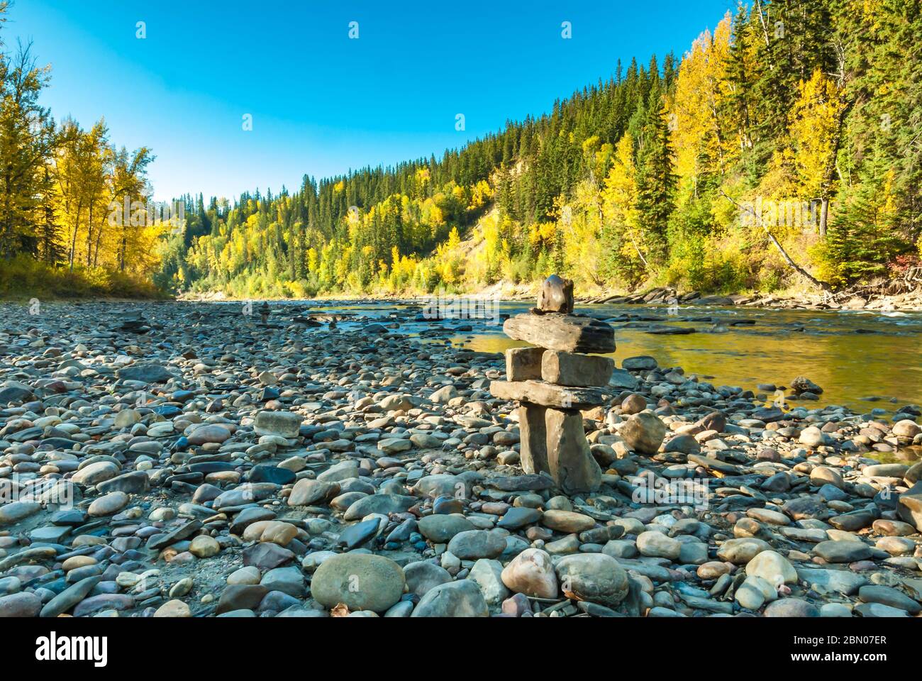 A stone inukshuk built on the banks of the Pembina River in central ...
