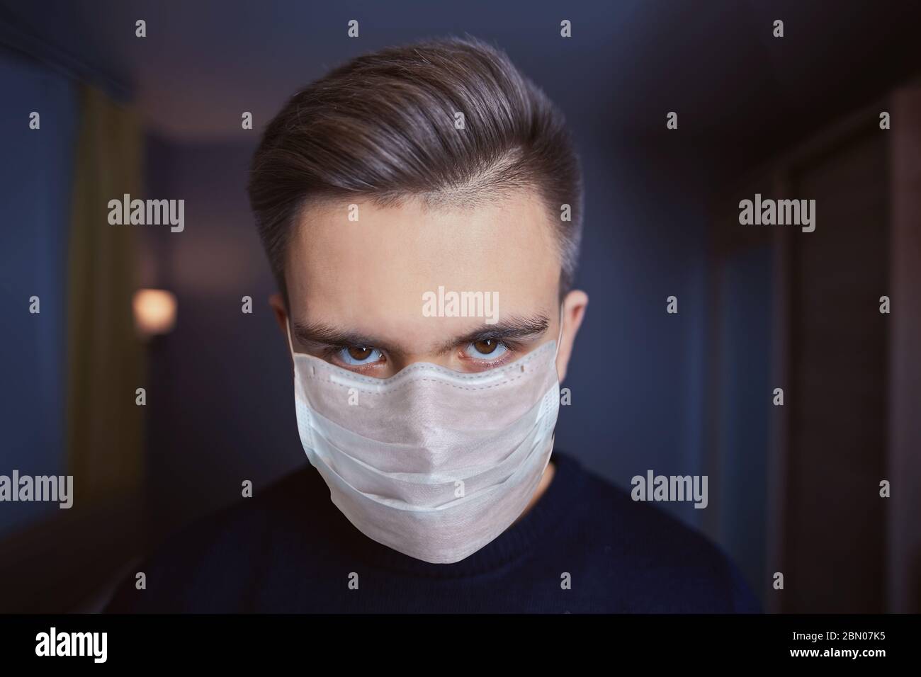 An alarming look of a young Caucasian male who is in self-isolation ...