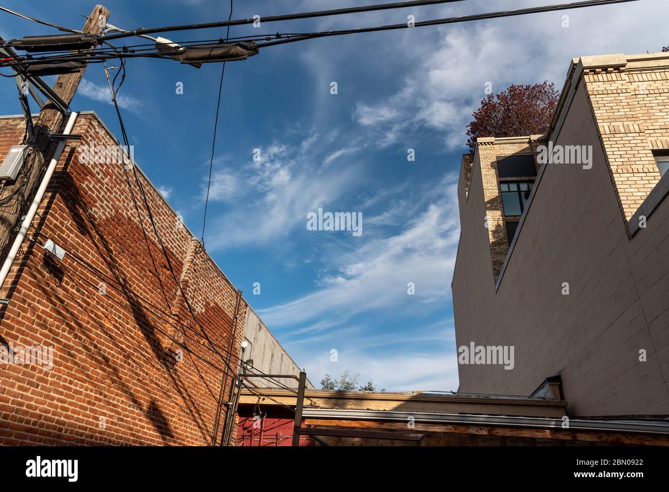 Bend, Oregon alley looking to a new building next to a historic brick ...