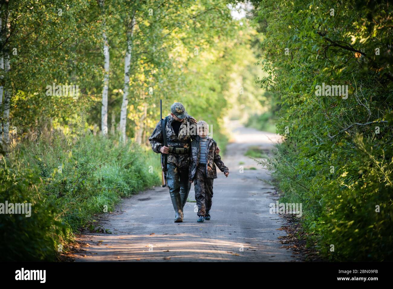 father pointing and guiding son on first deer hunt Stock Photo - Alamy