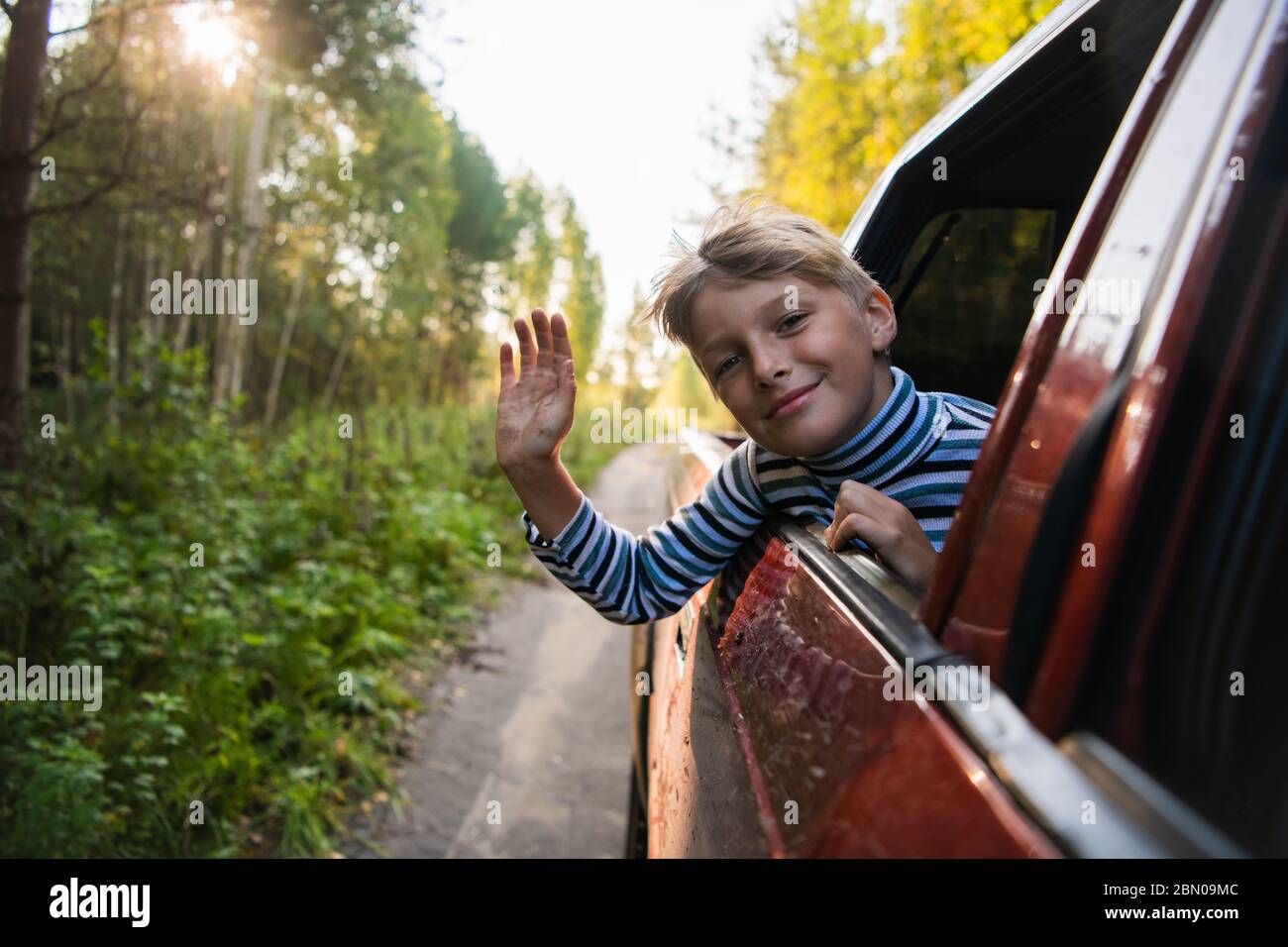 Happy kid travel by the car. He popped out of the window Stock Photo ...