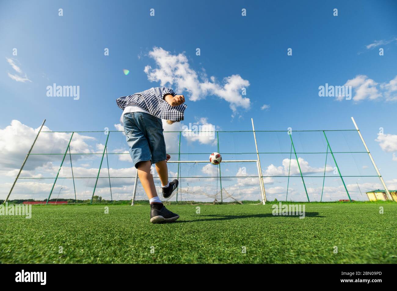 Child kicking foot ball hi-res stock photography and images - Alamy