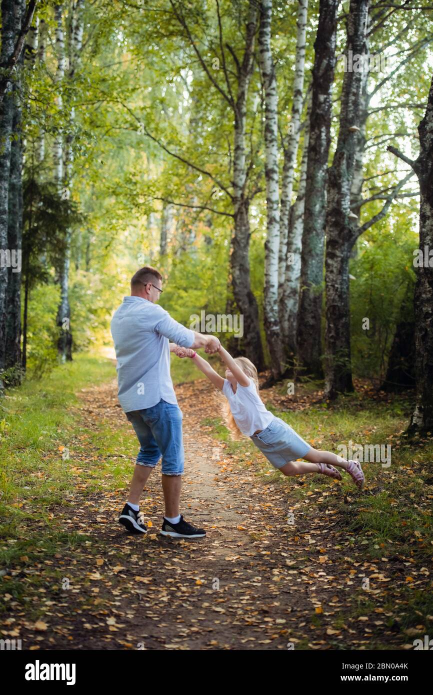 A Father and son in forest on a meadow Stock Photo - Alamy