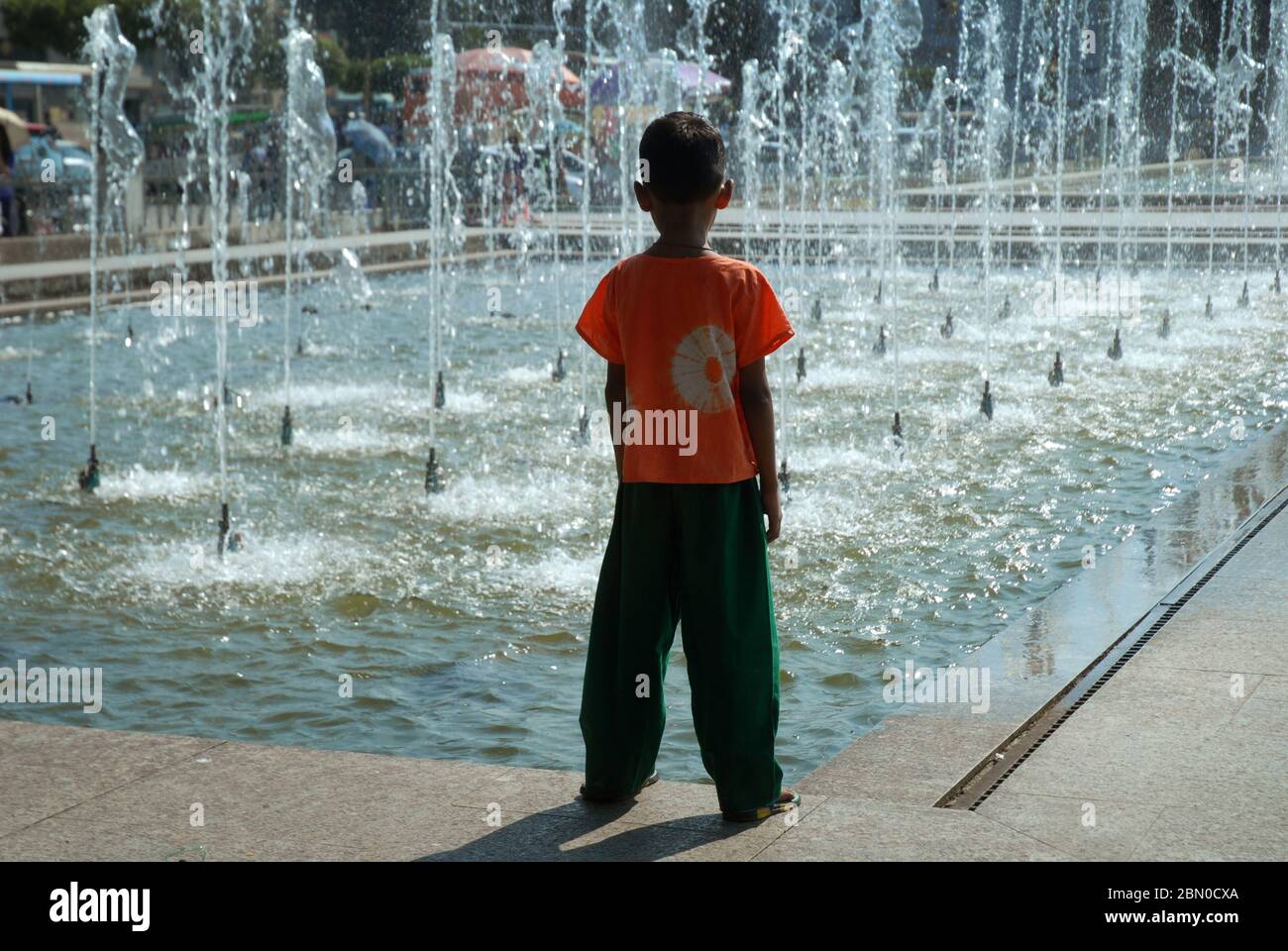 Young boy standing near the fountain, Maha Bandoola garden, Yangon ...