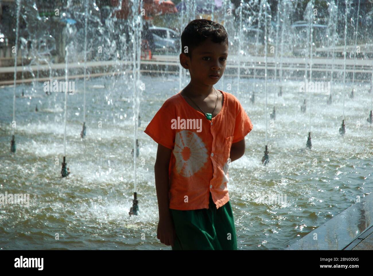 Young boy standing near the fountain, Maha Bandoola garden, Yangon ...