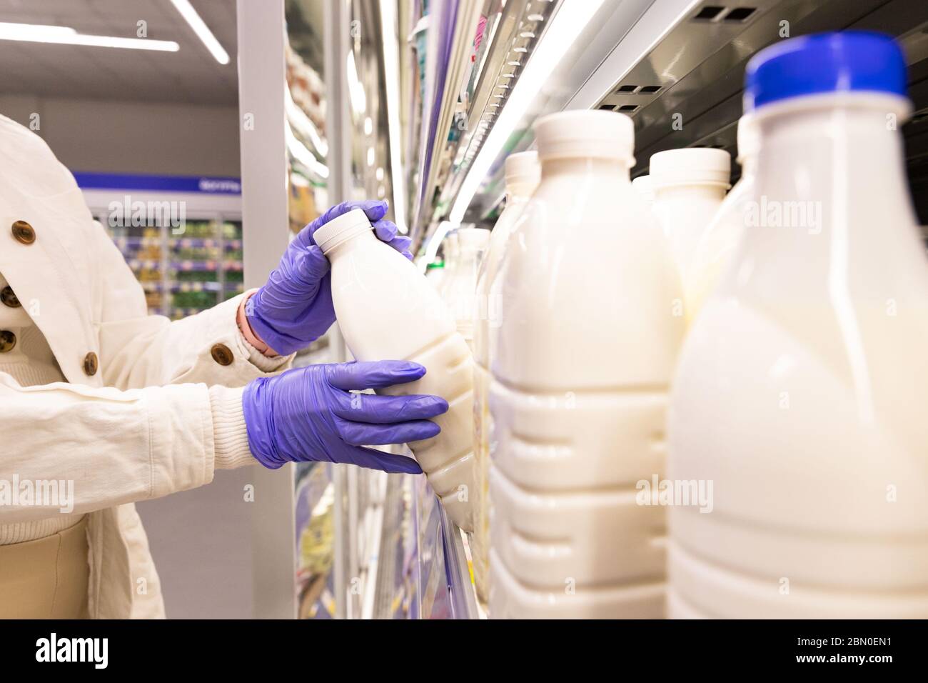 Woman protective mask chooses milk hi-res stock photography and images ...