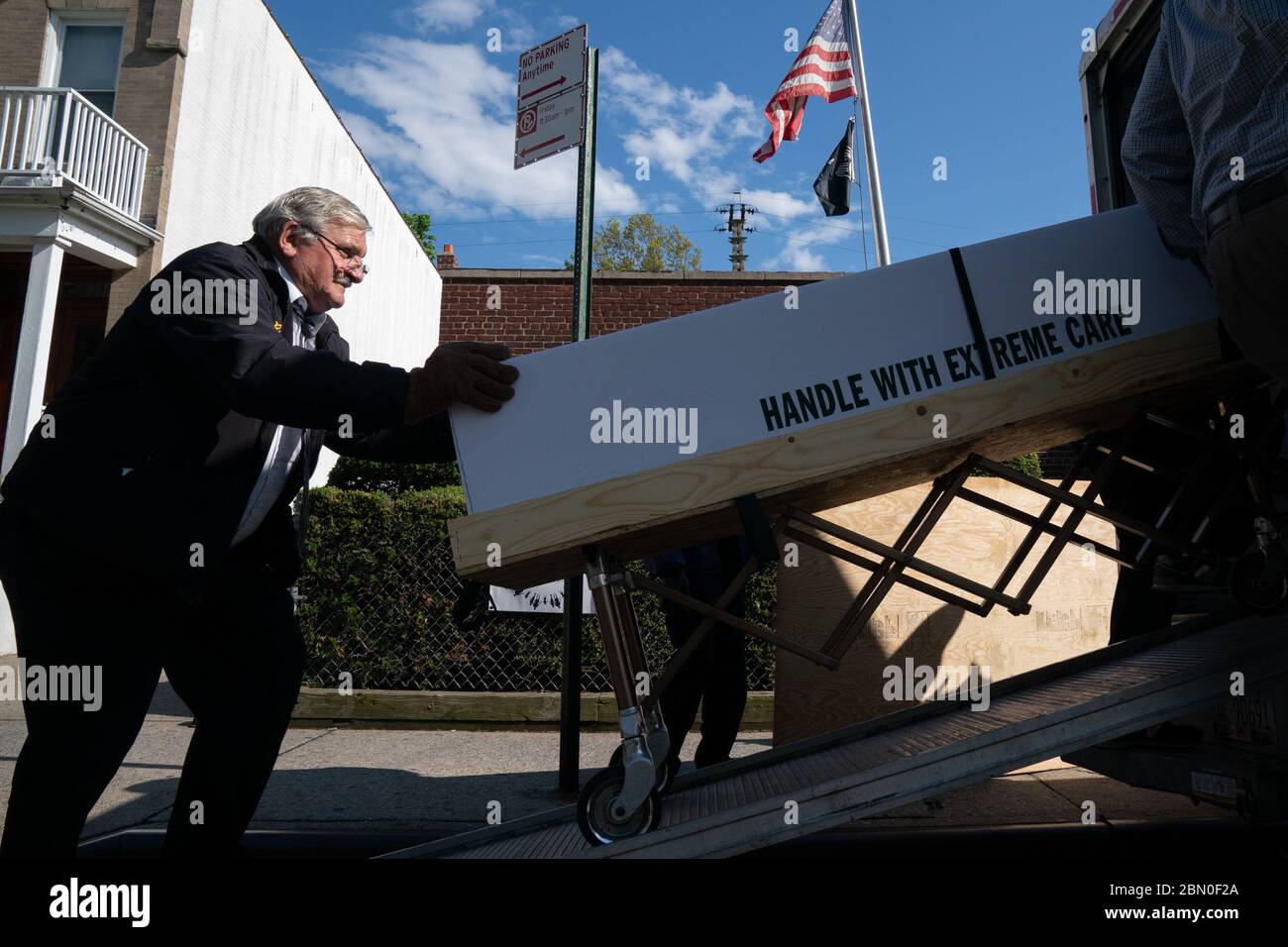 New York, NY, USA. 11th May, 2020. Ray Neufeld pushes a body onto a ...