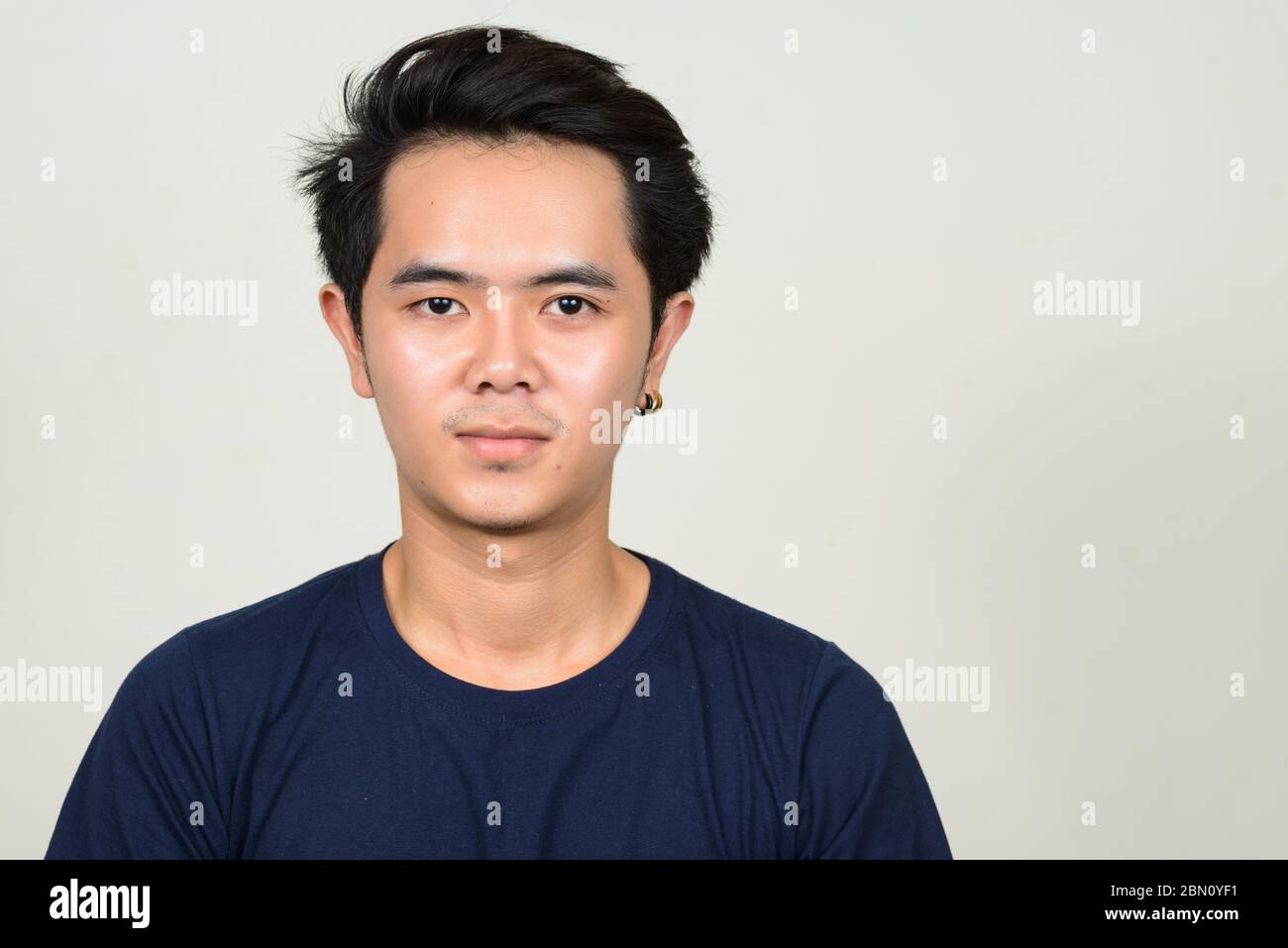 Portrait of young Asian man looking at camera Stock Photo - Alamy