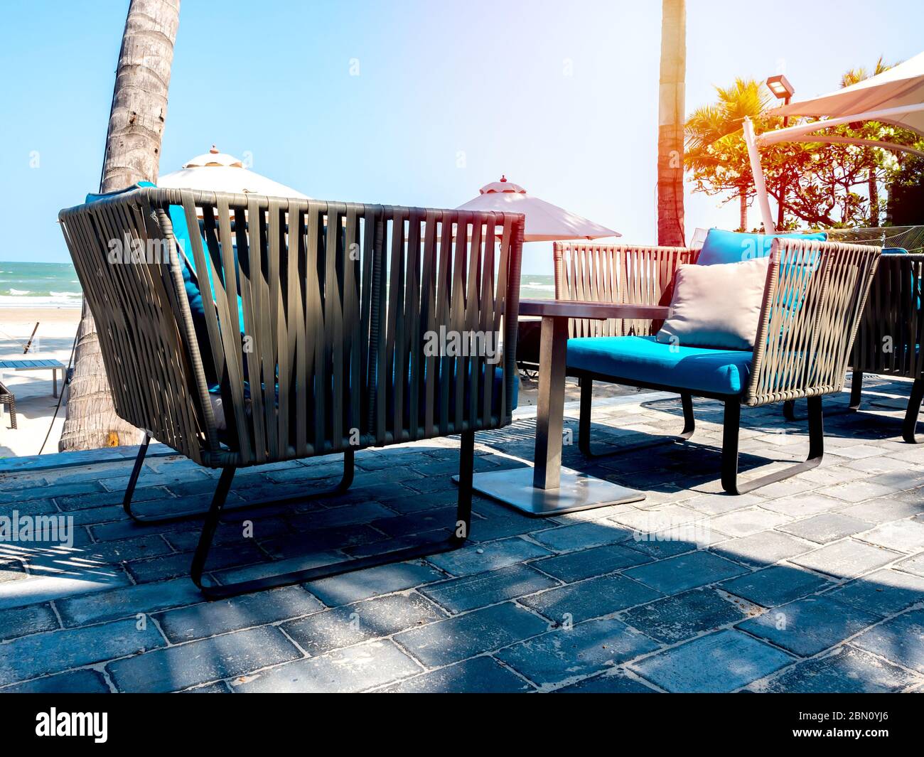 Modern chairs with round side table on balcony with sea view near the ...