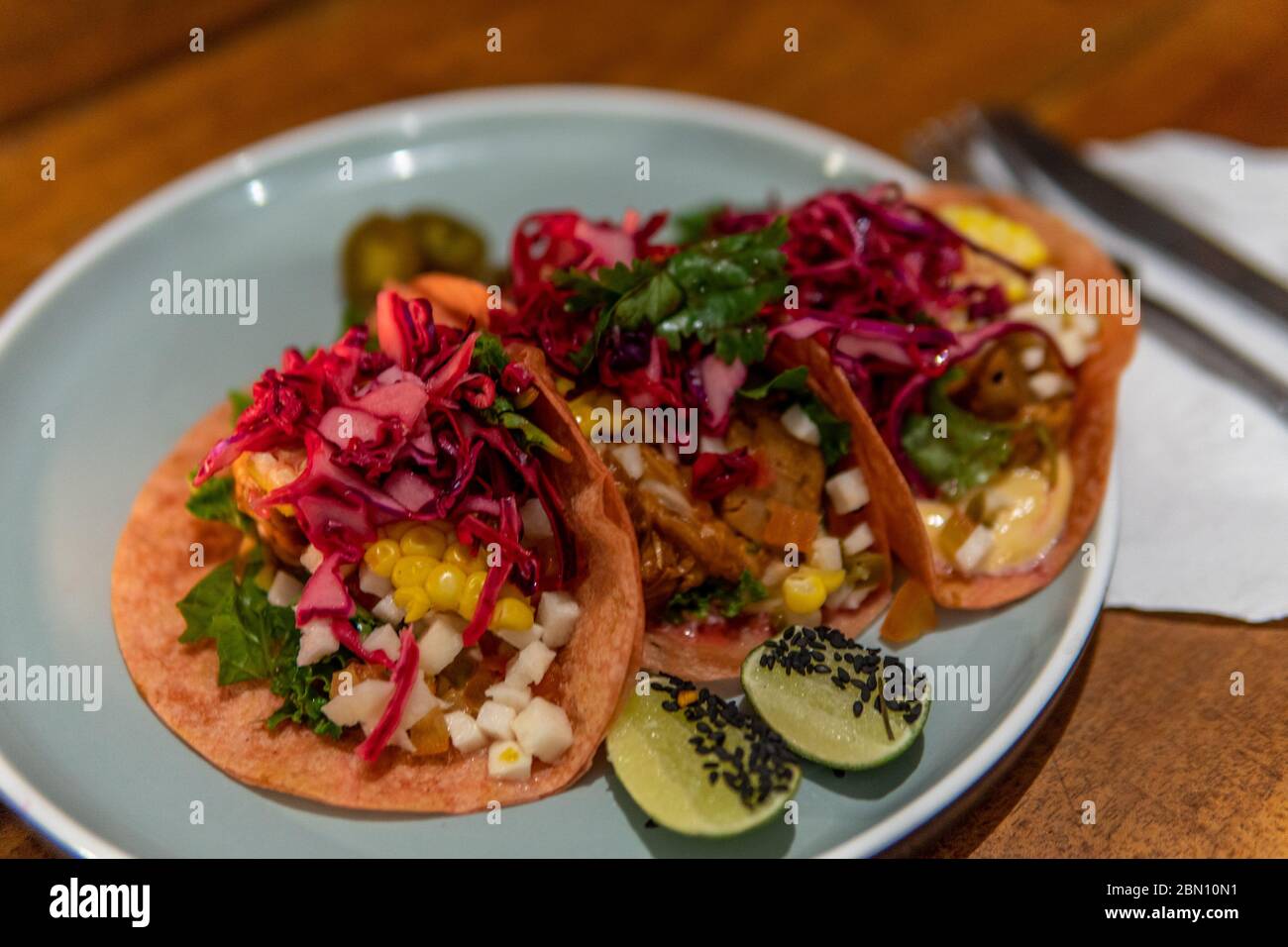 Three Vegetarian healthy soft shell tacos with lime on plate Stock ...