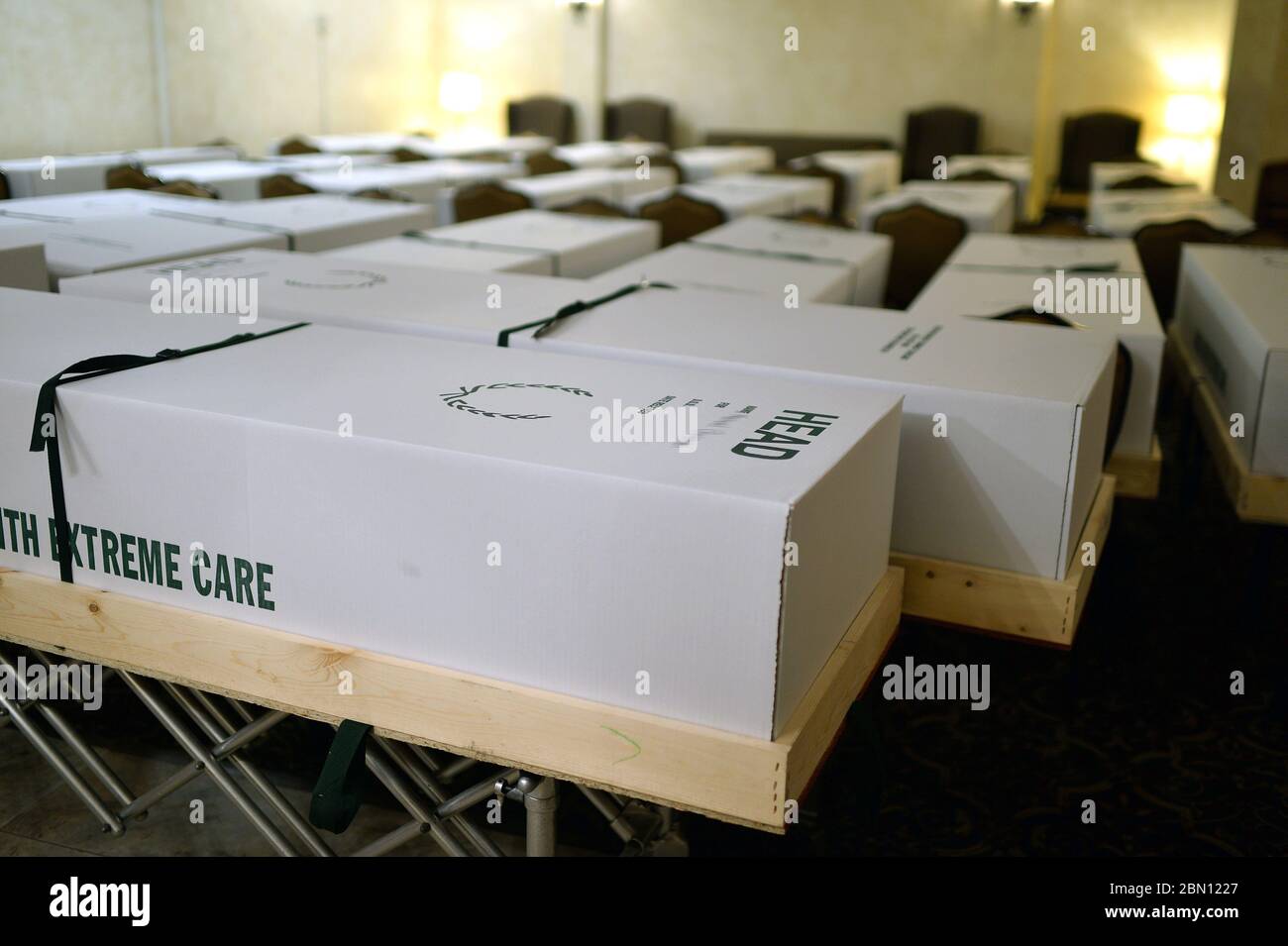 Bodies in cremation funeral caskets are lined up in rows sitting on ...