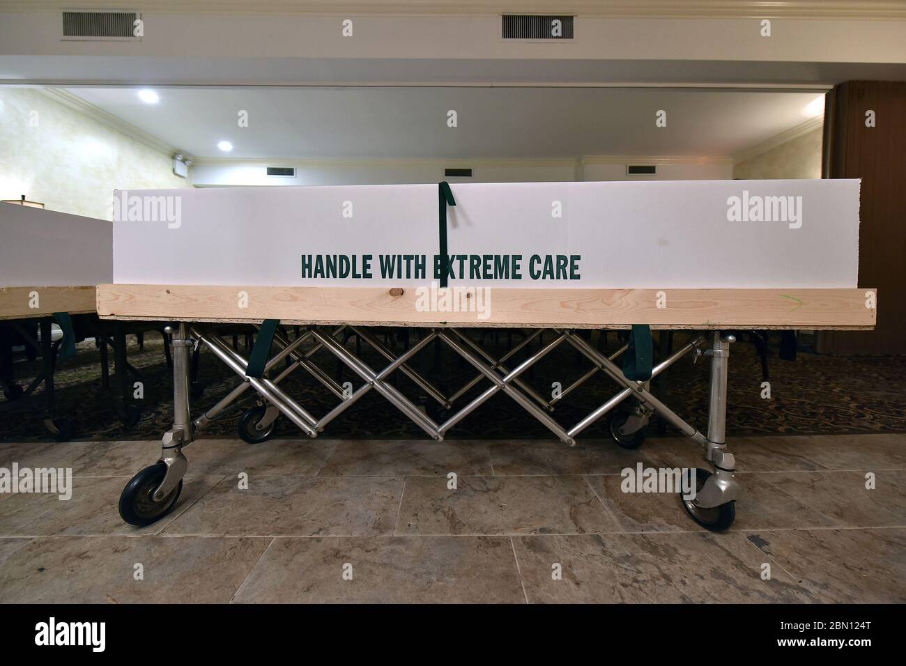 Bodies in cremation funeral caskets are lined up in rows sitting on ...