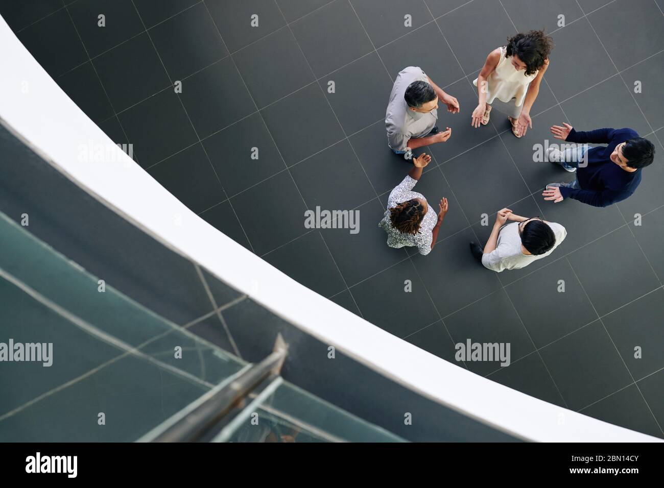 Group of confident business executives standing in circle when ...