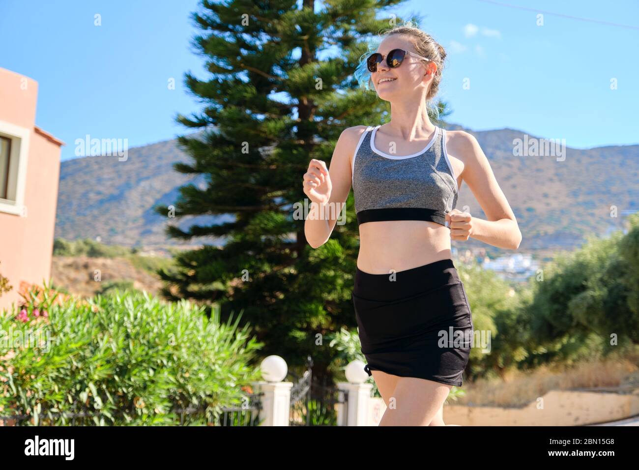Girl teenager runner, female running on mountain road Stock Photo - Alamy