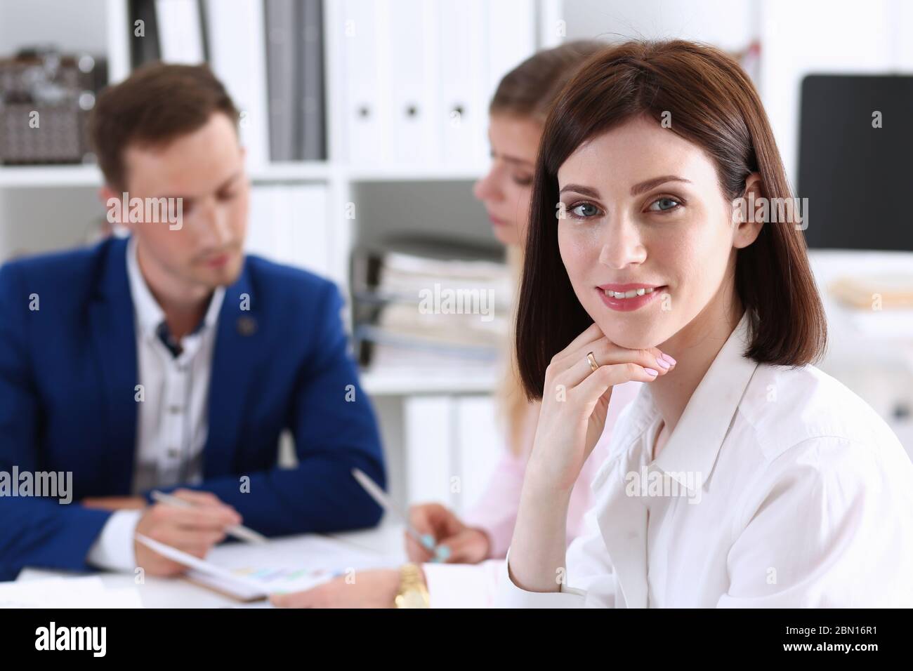 Beautiful smiling cheerful girl at workplace Stock Photo - Alamy