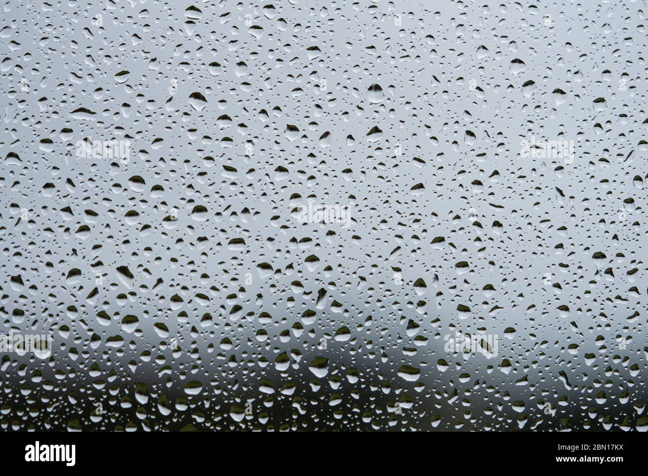 Rain drops on glass window. Dark grey textured background. Full frame ...