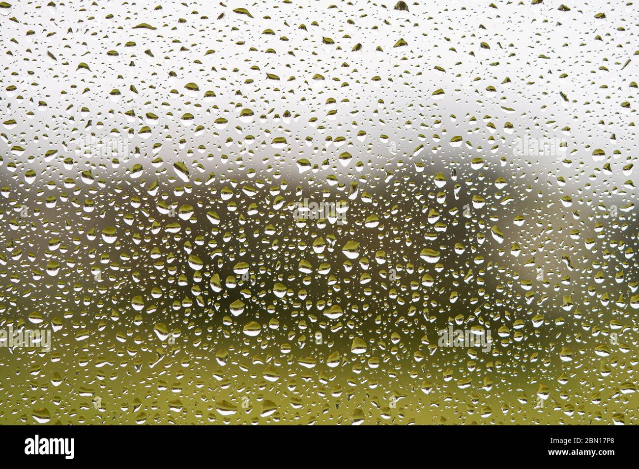Rain drops on glass window. Dark grey and green textured background ...