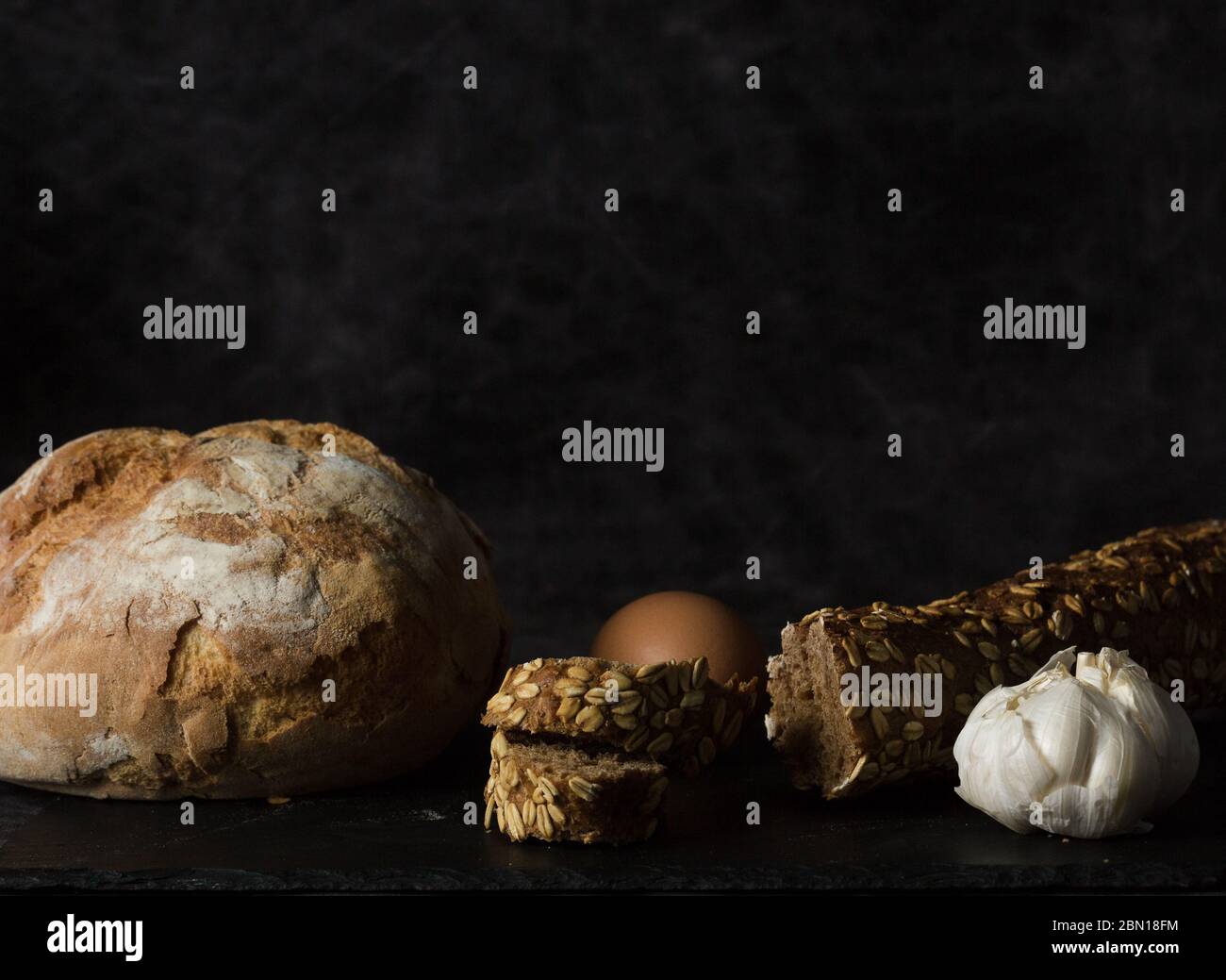Breaking Bread Homemade bread loaf on rustic dark background Stock ...