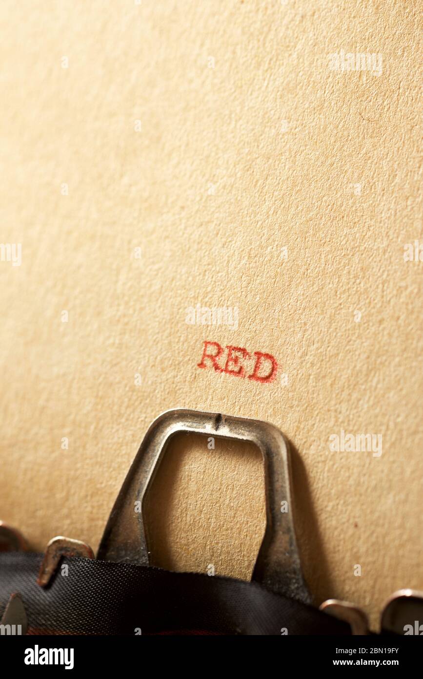 Red word written on a paper Stock Photo - Alamy