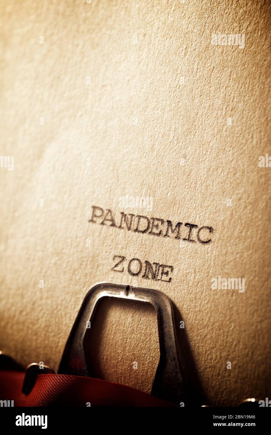 Pandemic zone text written on a paper Stock Photo - Alamy