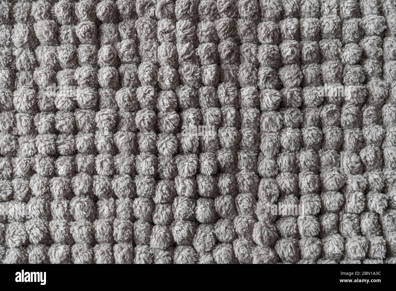 Texture of a gray blanket made of small balls Stock Photo - Alamy