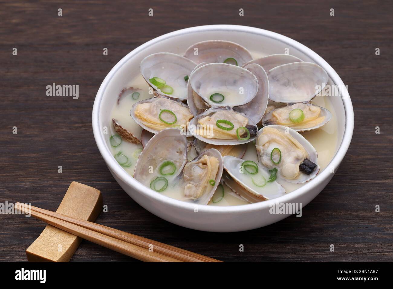 Japanese traditional cuisine, Sake steamed clams, Sakamushi, on table ...