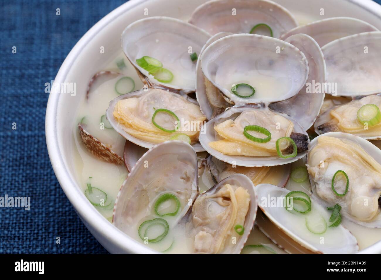 Japanese traditional cuisine, Sake steamed clams, Sakamushi, on table ...