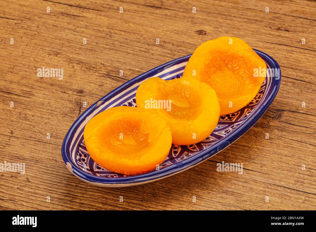 Marinated peaches fruit in the bowl with syrope Stock Photo - Alamy