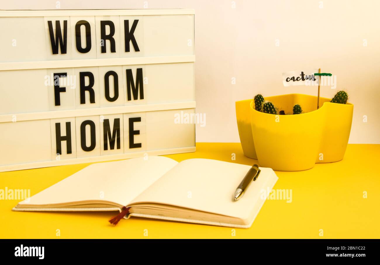 lightbox with text WORK FROM HOME with notebook pen and cactus and TO ...