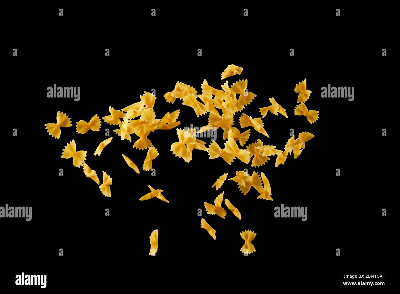 Italian flying raw pasta isolated on black background. macaroni ...