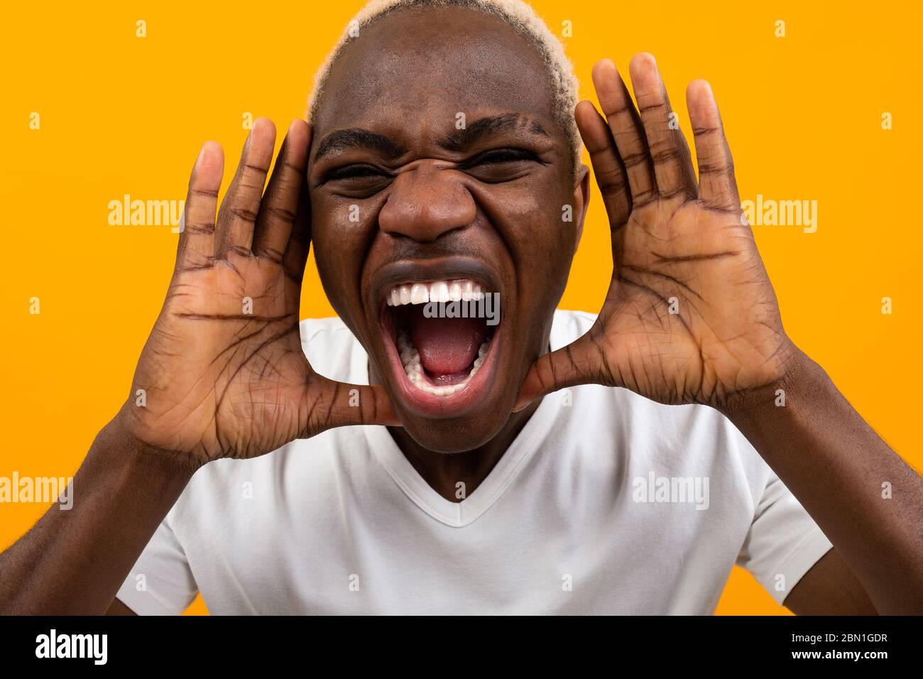 young black african man screaming loudly Stock Photo - Alamy