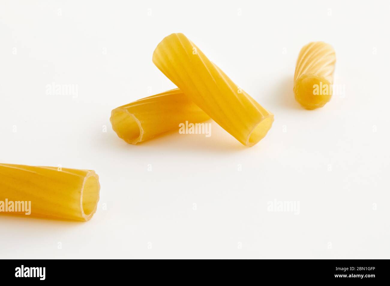 Italian raw dry pasta rigatoni isolated on white background Stock Photo ...