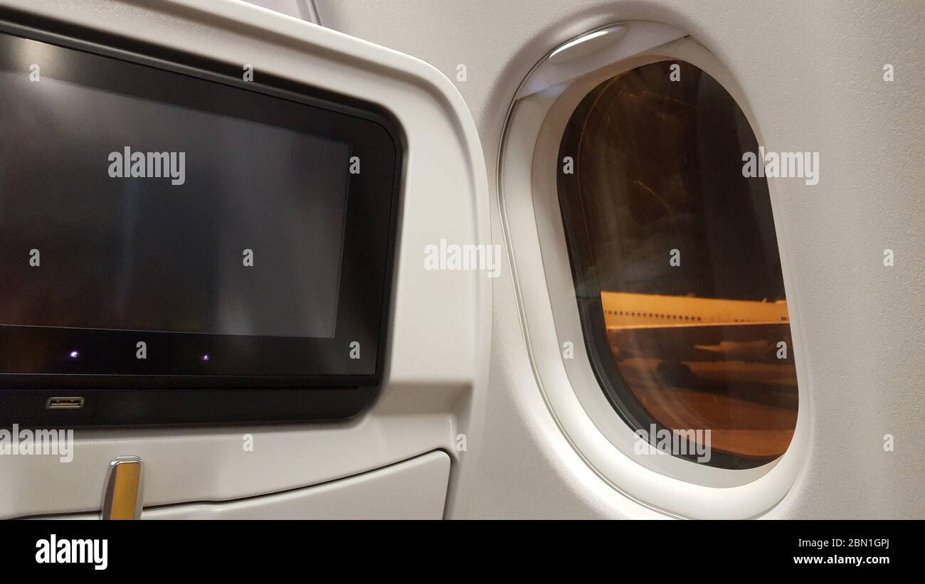 View from the airplane window of an airport in the dark. White and ...